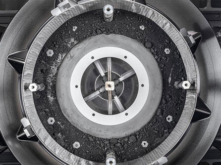 A top-down view of the OSIRIS-REx sample container with the lid removed ...