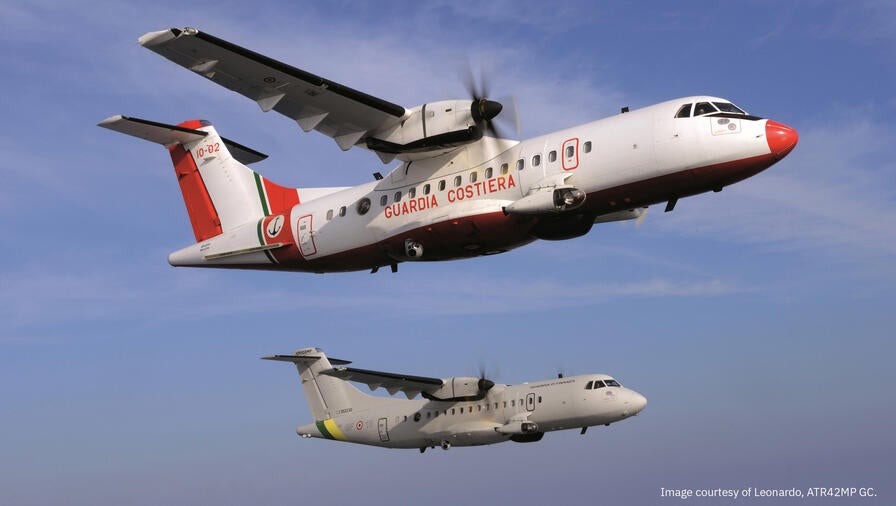 Two Airplanes in flight side by side against a bright blue sky