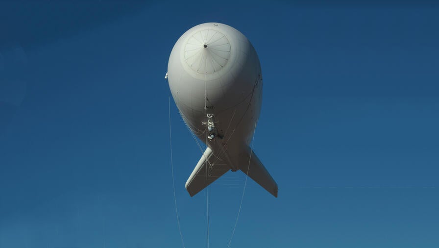 Lockheed Martin Aerostat deployed and floating against a clear blue sky